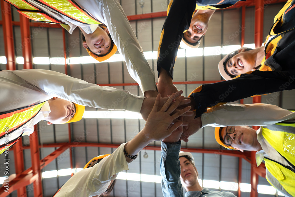 Group of male and female factory labor join hands together after finish ...