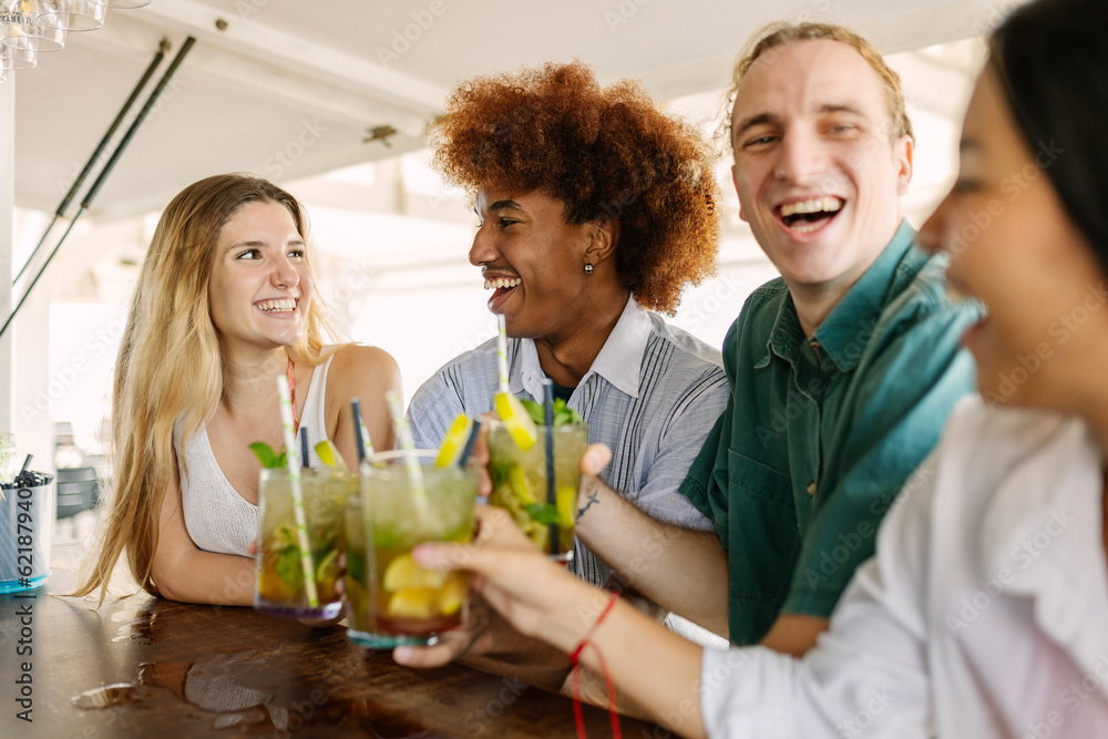 Young diverse group of friends drinking cocktails enjoying happy hour ...