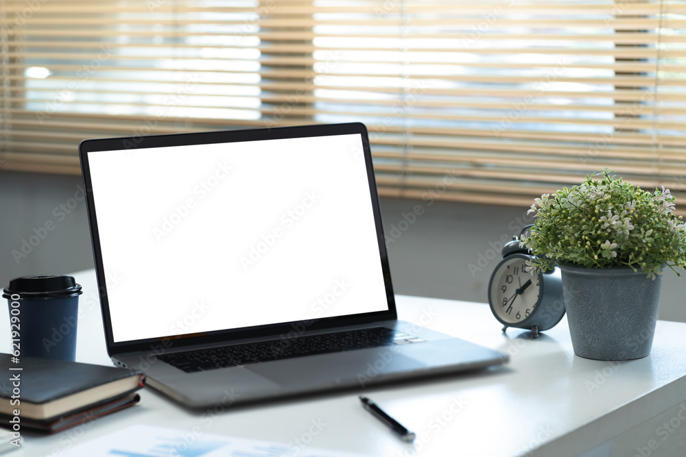 Empty white screen laptop. blank white screen. Mockup image in office ...