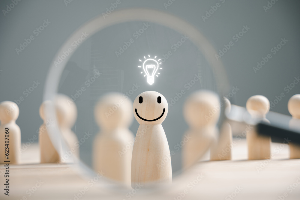 Finding with a magnifying glass, happy wooden person figure standing ...