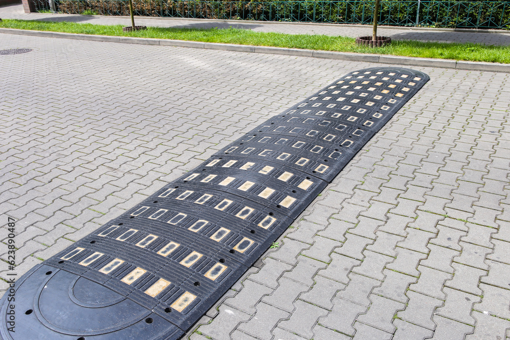 Road obstacle for speed limit and safe driving. The barrier, screwed to ...