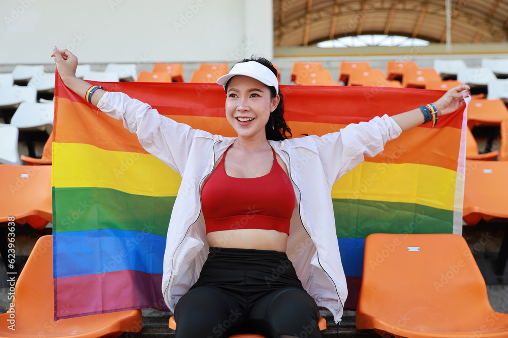 Happy and excited young female asian transgender LGBT sport fan ...