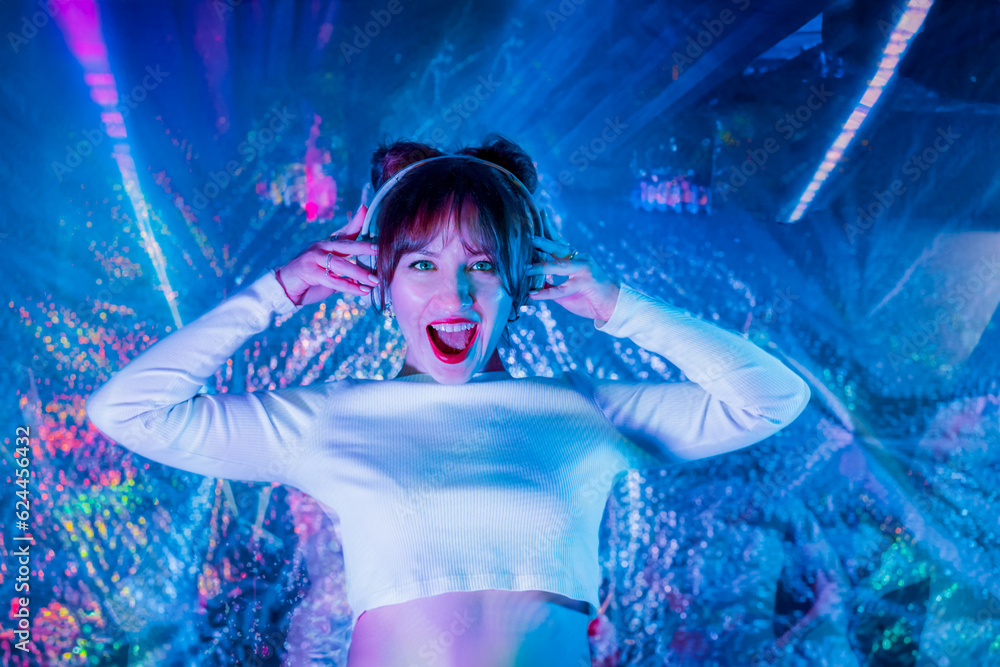 Portrait of emotional screaming woman in white clothes and headphones ...