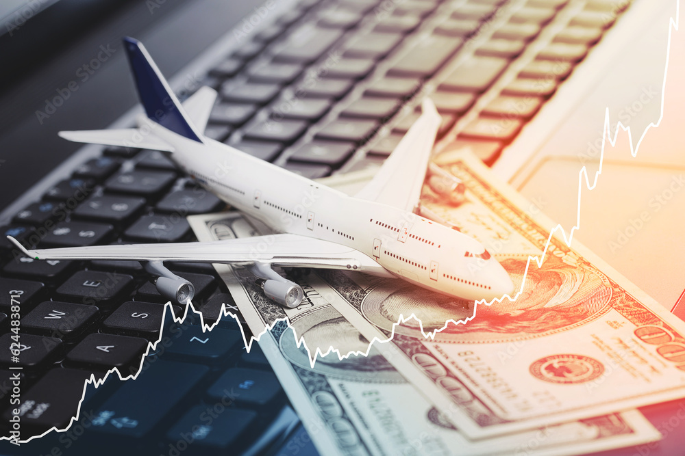 Toy aircraft, dollar bills and rising chart representing airfare rise ...