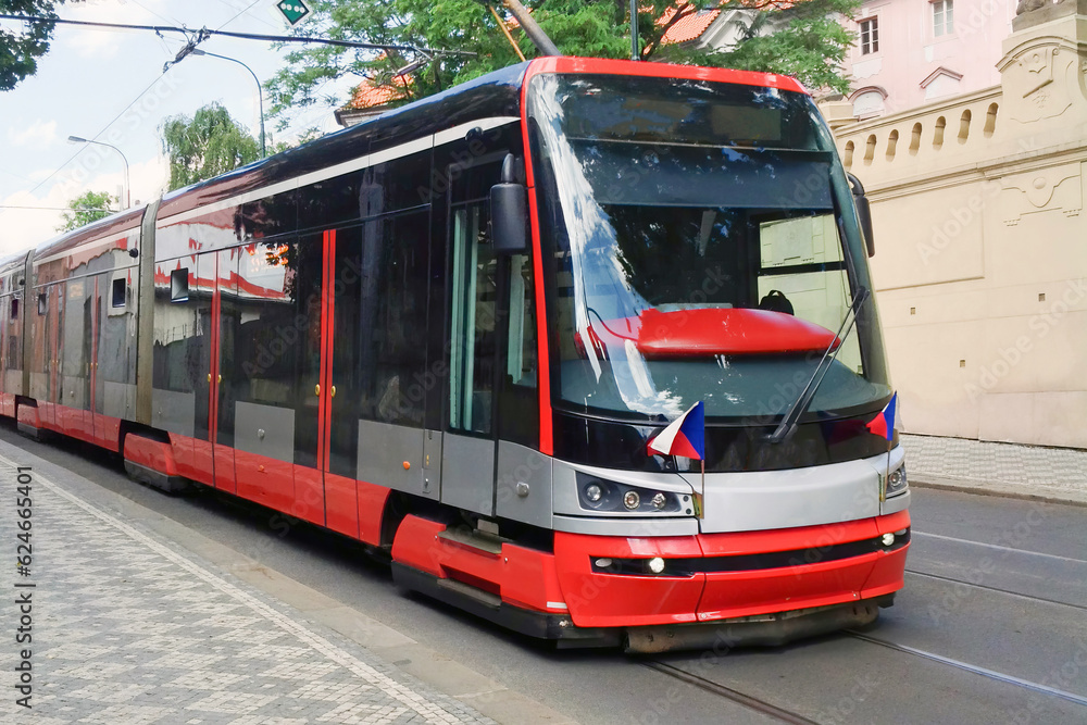 Modern Tram in old stree of Prague in a summer day, Czech Republic. The ...
