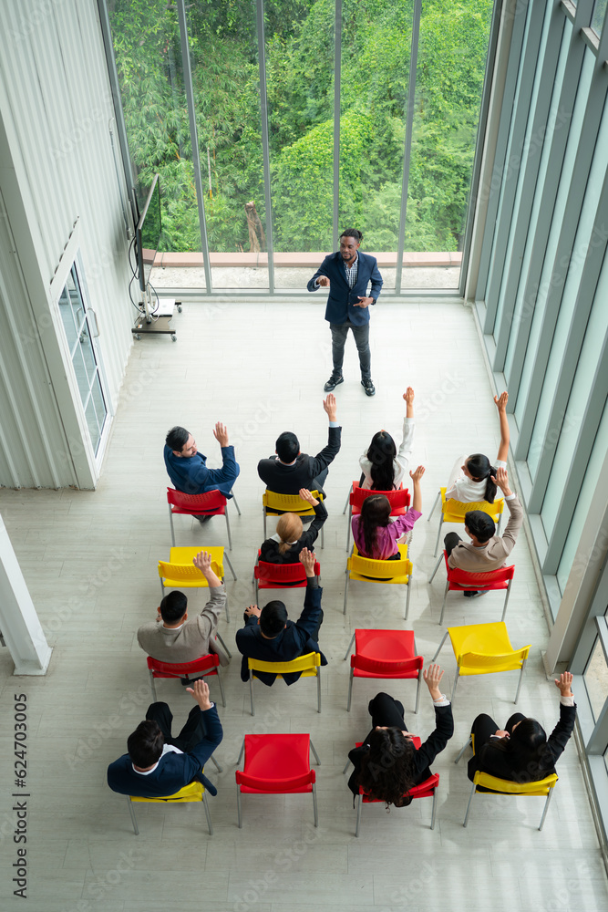 Top view of a group of business people sitting and listening to a ...