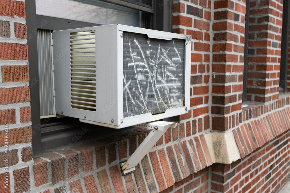 Window Air Conditioner in the Window of an Old Brick Apartment Building ...
