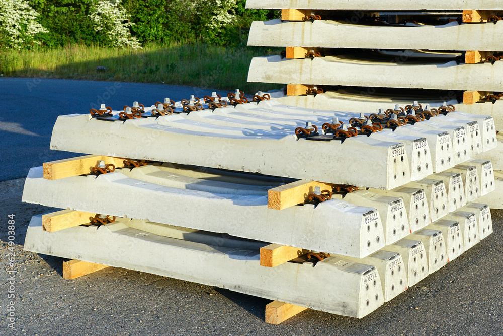 Before track repair stacked new white reinforced concrete railroad ...