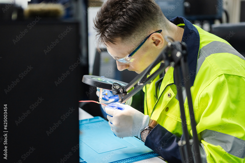 man electrical engineer using solder repairing instrument microchip electronic instrument ...