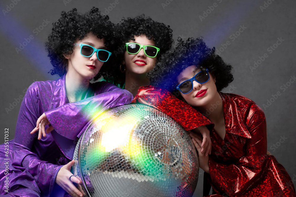 Music or dance group of girls in disco style posing on a gray ...