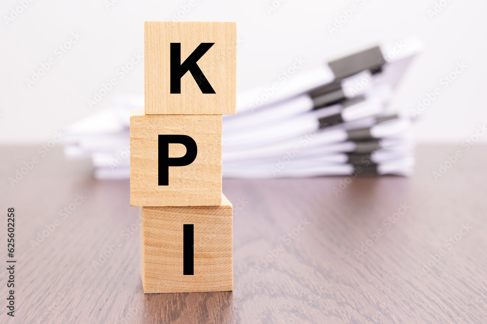 wooden cubes with letters KPI arranged in a vertical pyramid, stack ...