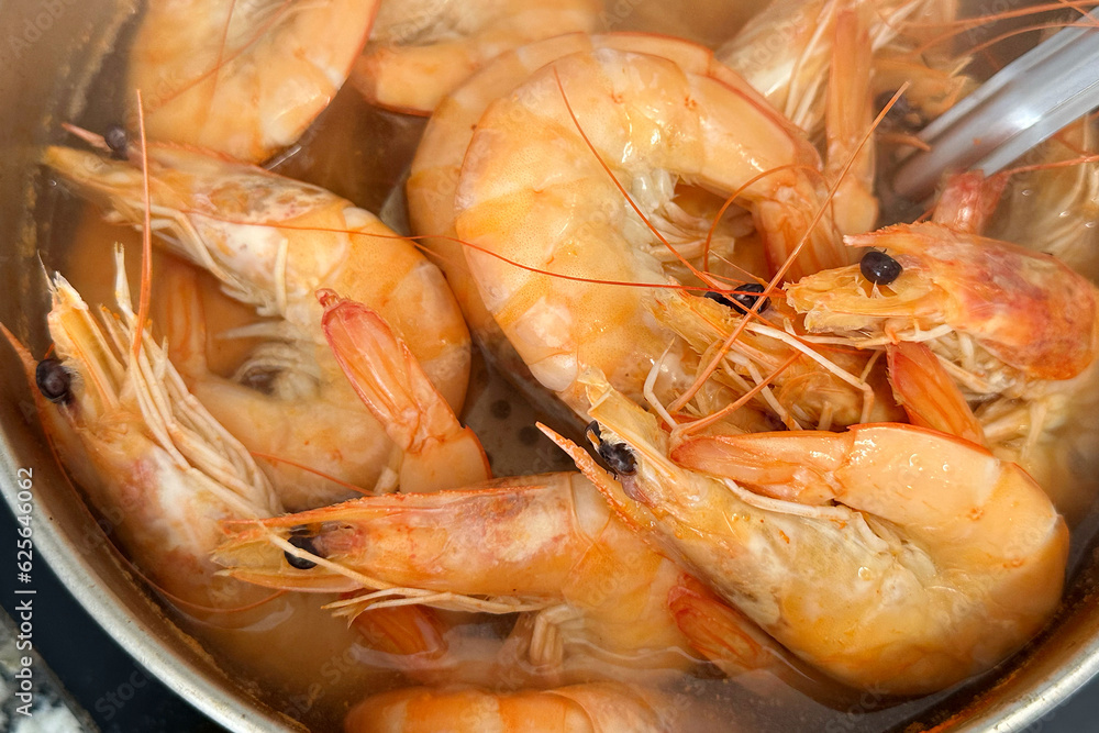 Cooking shrimp on stove in kitchen. Shrimp boiled in a pot on fire ...