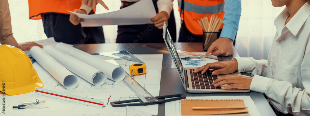 Engineer partner drawing and working on blueprint design together on ...