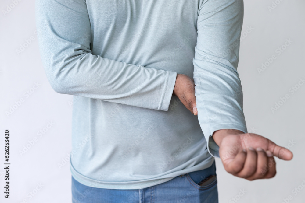 South asian Indian man suffering from elbow joint pain, concept of ...