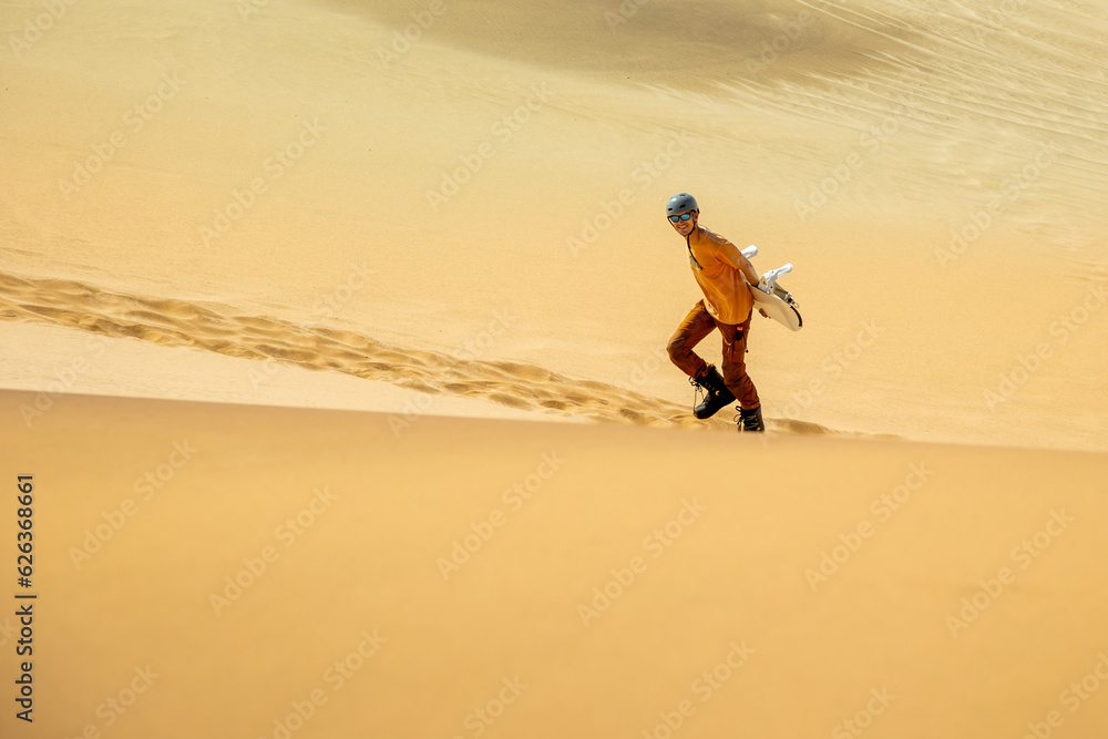 Single sand boarder climbing a dune near Swakopmund, Skeleton Coast ...