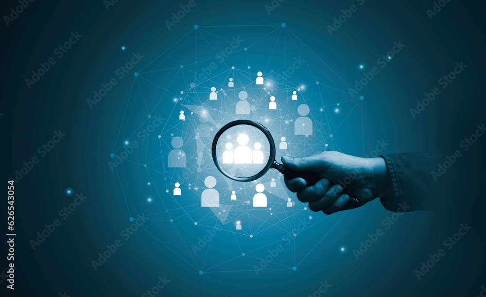 Hand holding magnifier glass with human icon for focus customer target ...