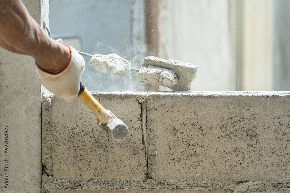 Hand of worker using hammer smashing and demolish on brick wall at ...