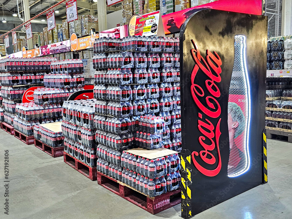 Plastic bottles display of Coke Coca-cola on display piled in multiple shelves on supermarket ...