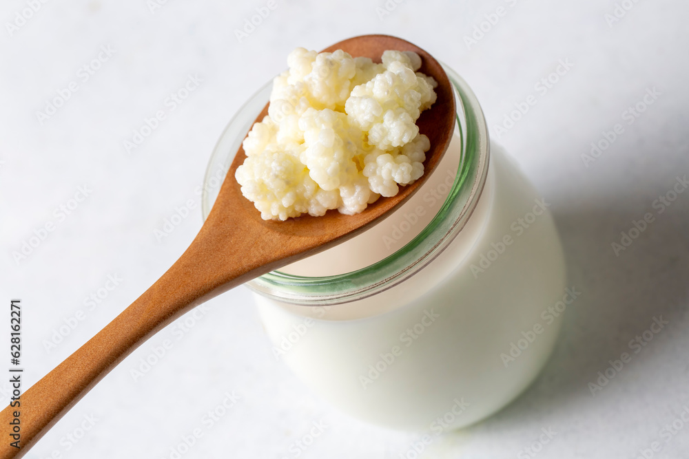Kefir fermented milk drink with kefir grains. Homemade kefir stands in ...