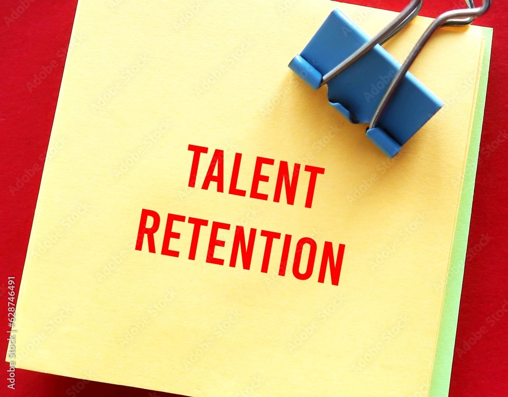Office note on red background with text typed TALENT RETENTION - set of ...