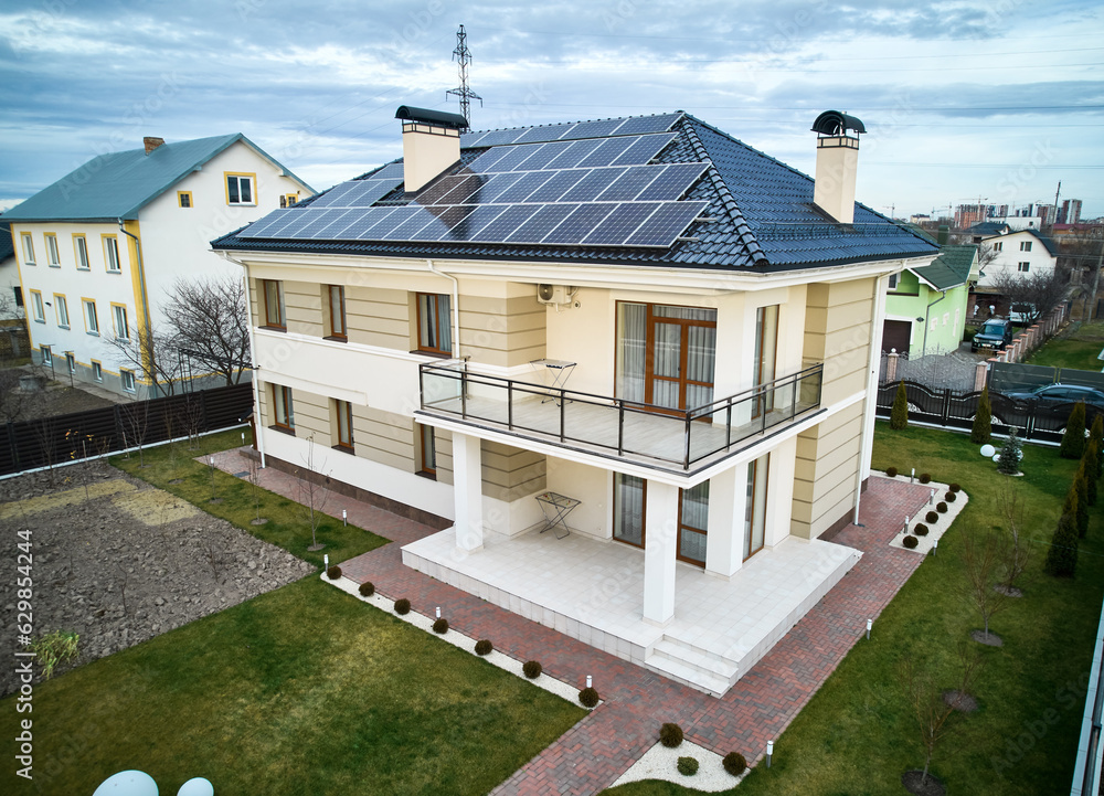 Residential house with photovoltaic solar panel modules on rooftop ...