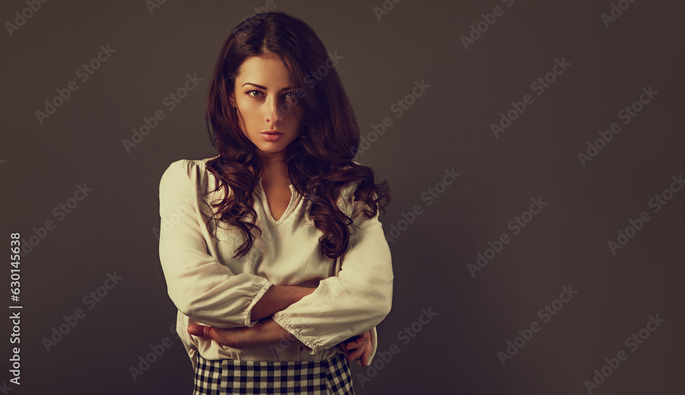 Beautiful serious makeup woman with long brown healthy wavy hair style ...