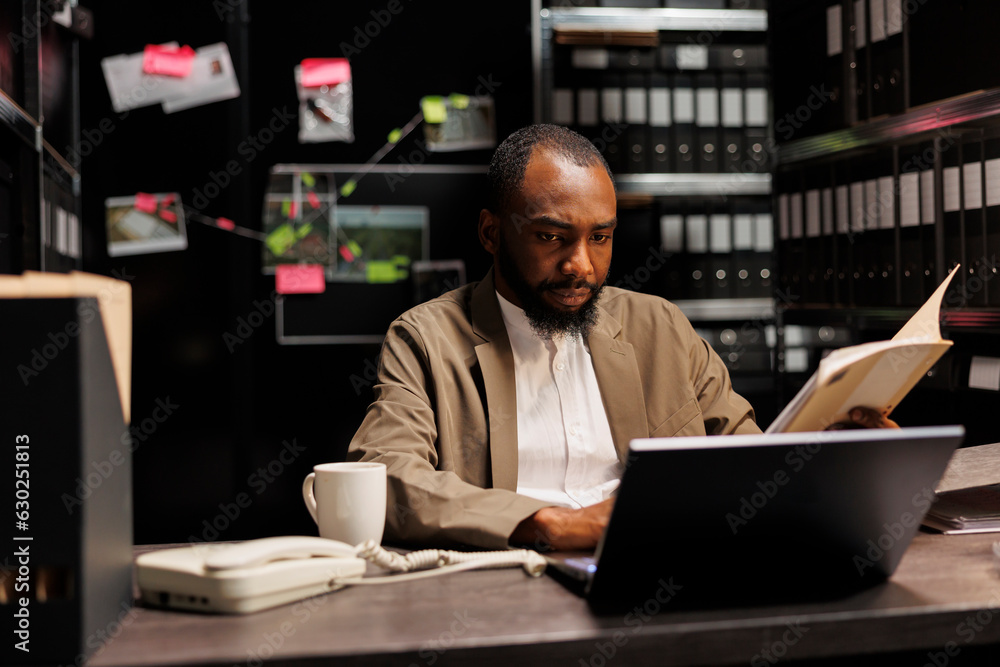 African american detective working late, conducting investigation in ...