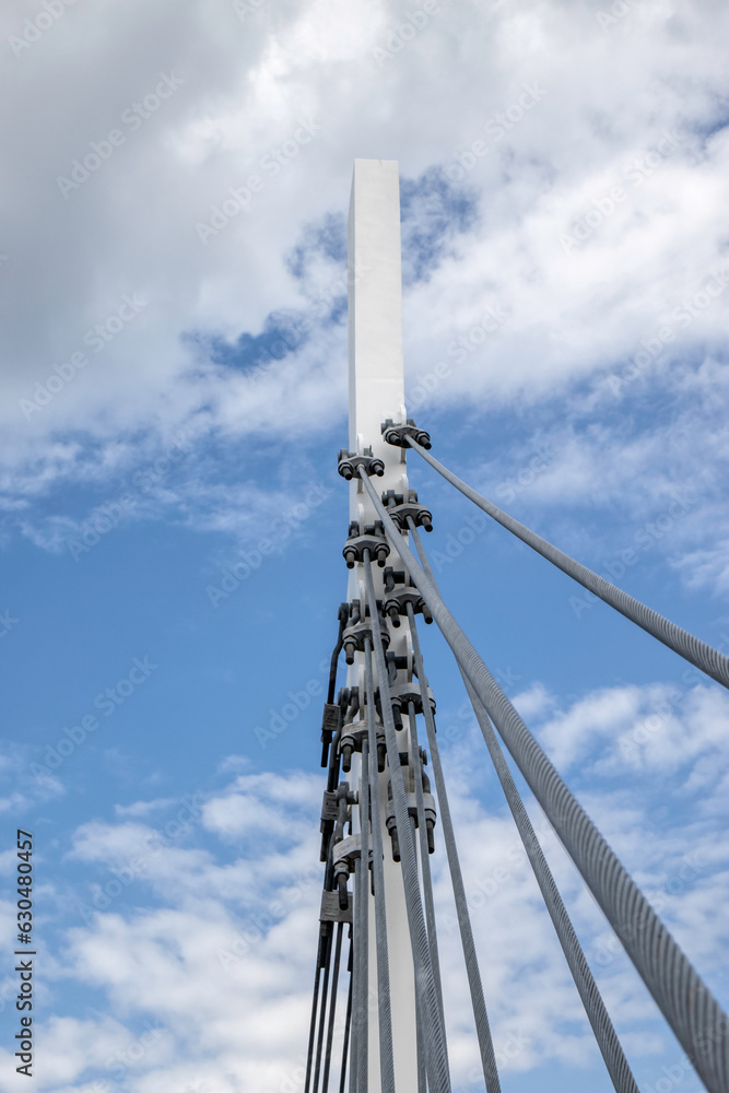 Large rectangular wooden bridge support column fastened by heavy steel ...