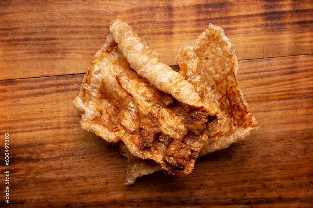 Chicharron. Crispy Fried pork rind, are pieces of aired and fried pork ...