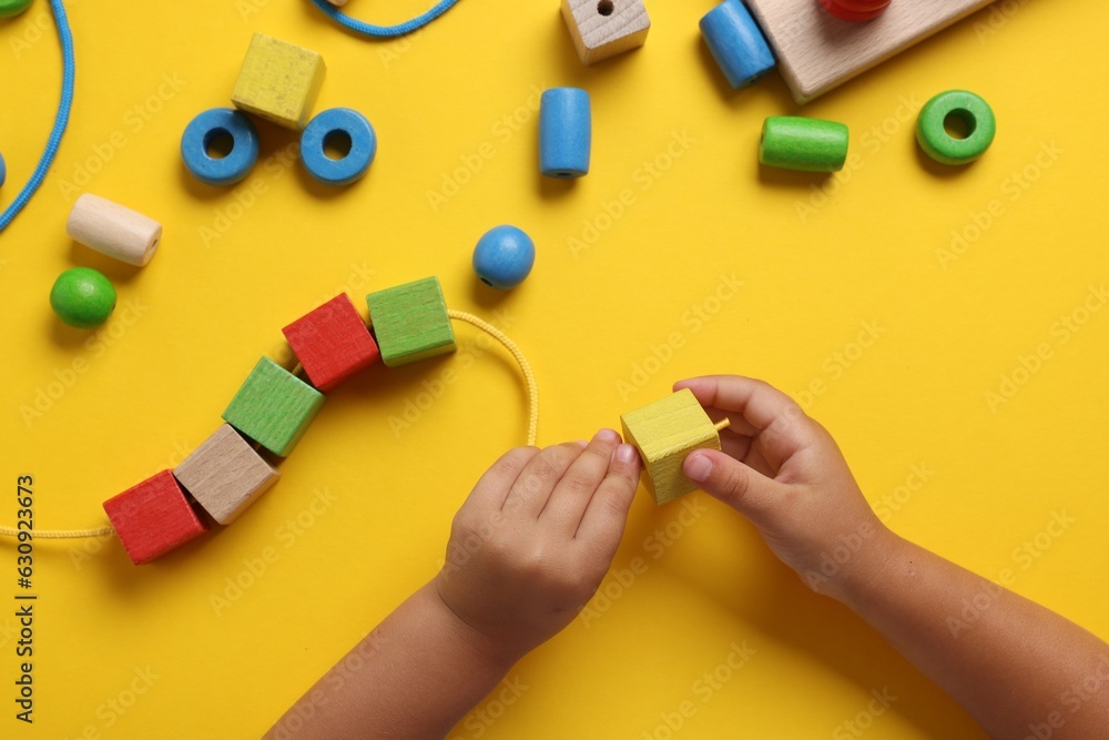 Motor skills development. Little child playing with wooden pieces and ...