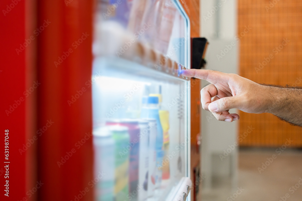 Young man using automatic vending machine buy drink and food. Press ...