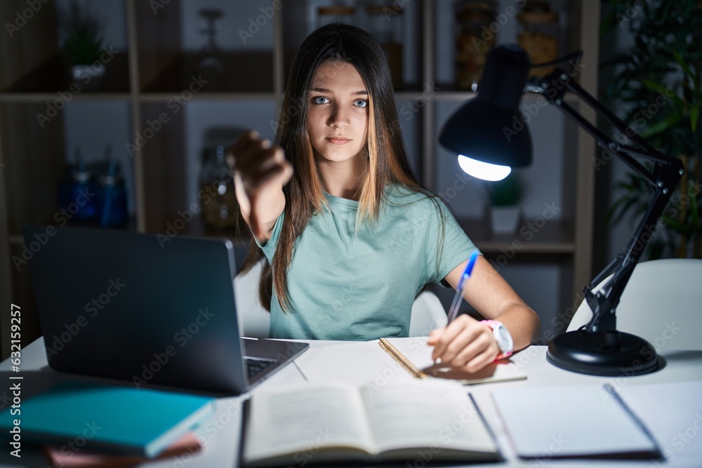 Foto de Stock Teenager girl doing homework at home late at night ...