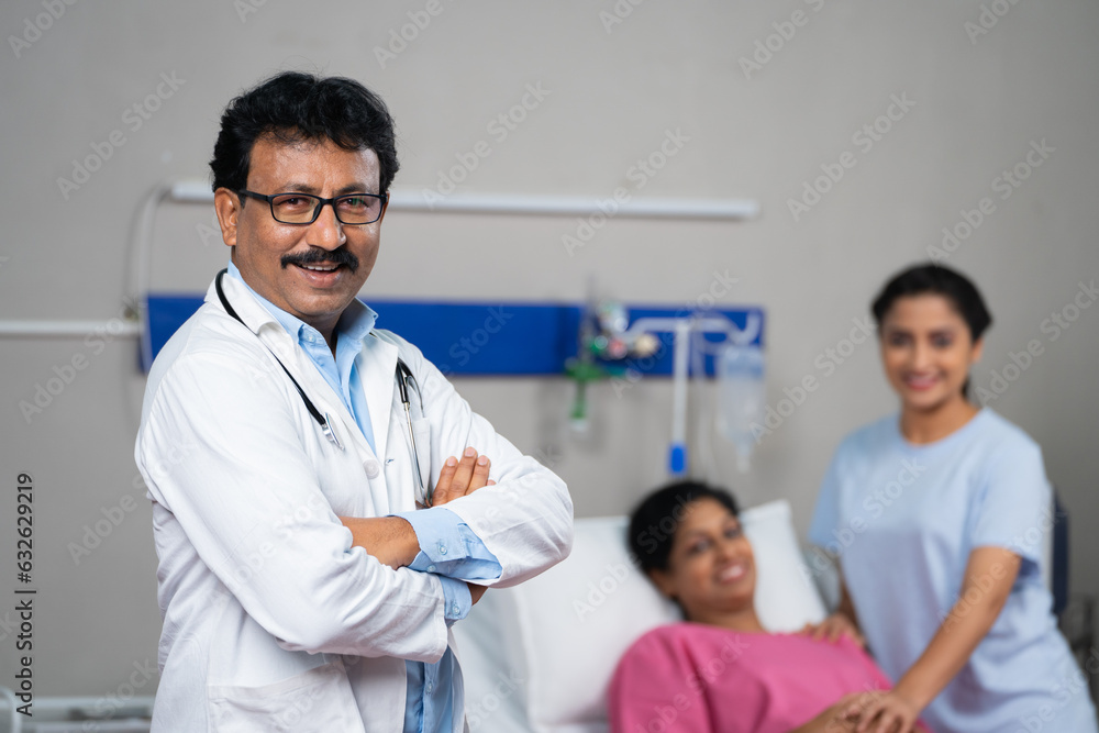 Rack focus shot, confident indian doctor standing with crossed arms in ...