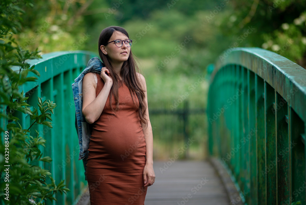 Caucasian Young Pregnant woman Tummy belly summer green bridge touching ...