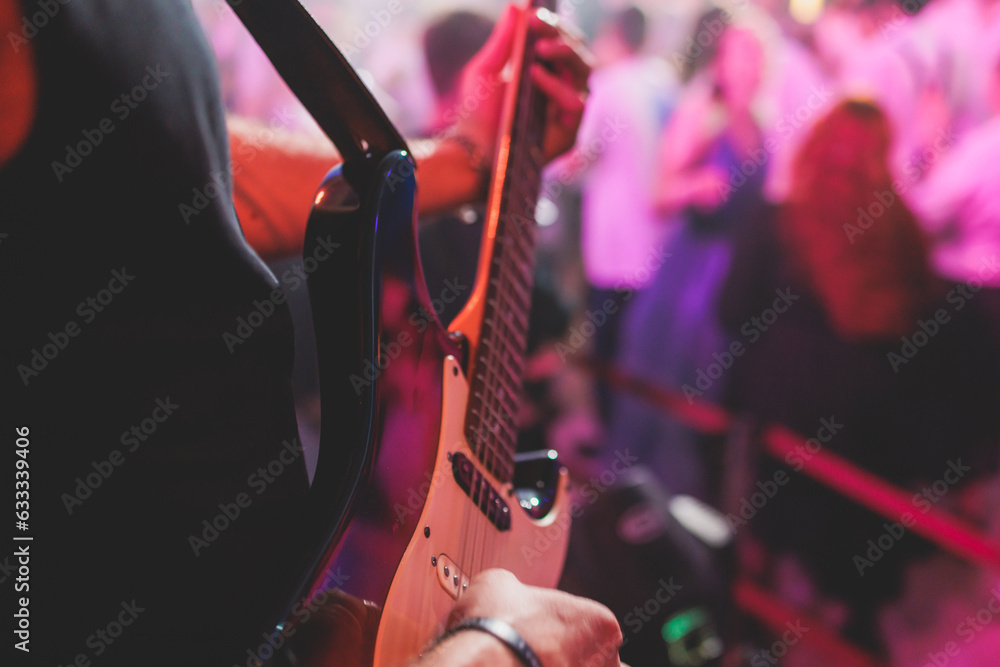 Concert view of an electric guitar player with vocalist and rock band ...