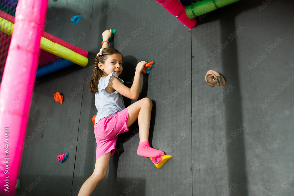 Beautiful excited child smiling while rock climbing and playing Stock ...