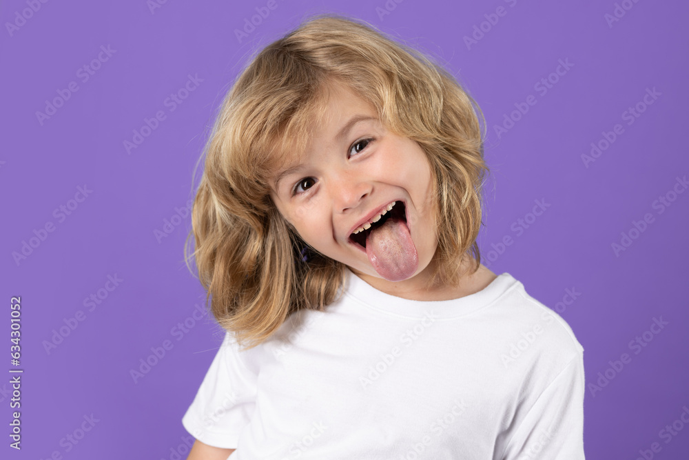 Excited child with tongue out on blue isolated background. Portrait of ...