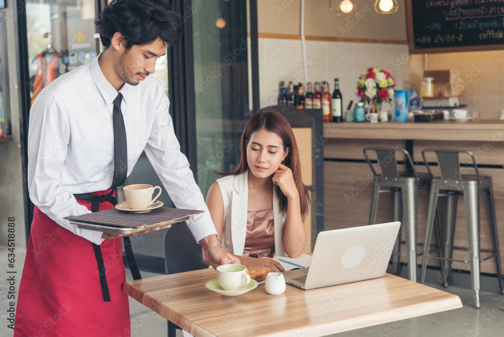 Restaurant business Handsome waiter serving food to young beautiful ...