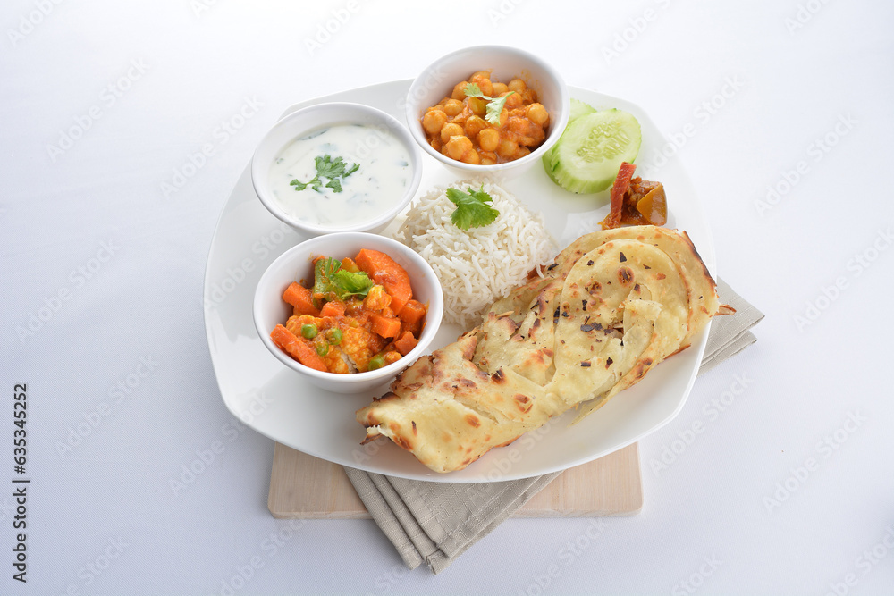 Indian traditional baked roti prata canai with curry vegetables, yogurt ...