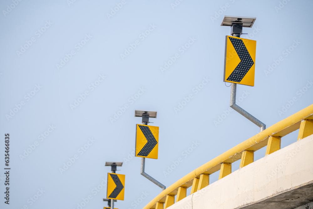 Yellow traffic signs guide drivers along curve roads. Symbols ensure ...