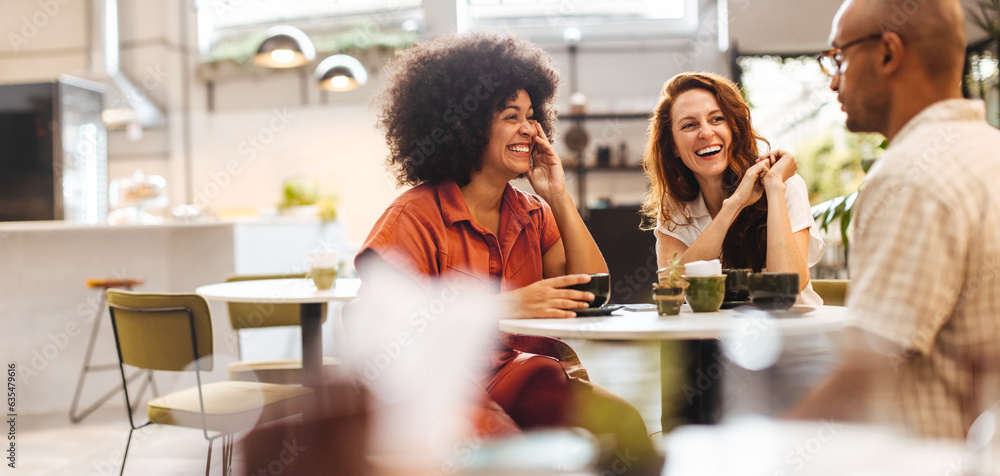 Friends having a good time, chatting over coffee in a restaurant Stock ...