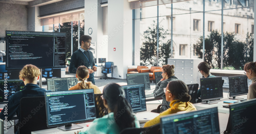 Teacher Giving Lesson to Diverse Multiethnic Group of Female and Male Students in College Room ...