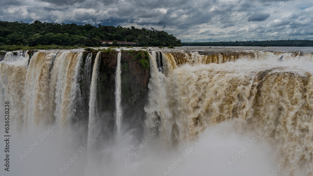 The powerful streams of the waterfall collapse into the abyss, bubbling ...