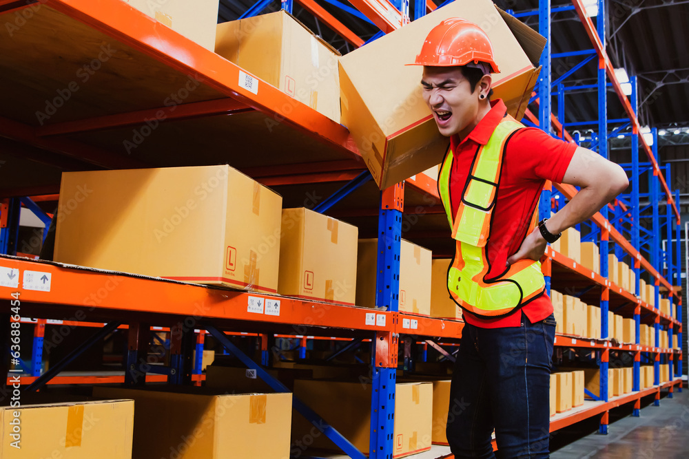 Back pain worker : Asian male worker working in warehouse carrying ...