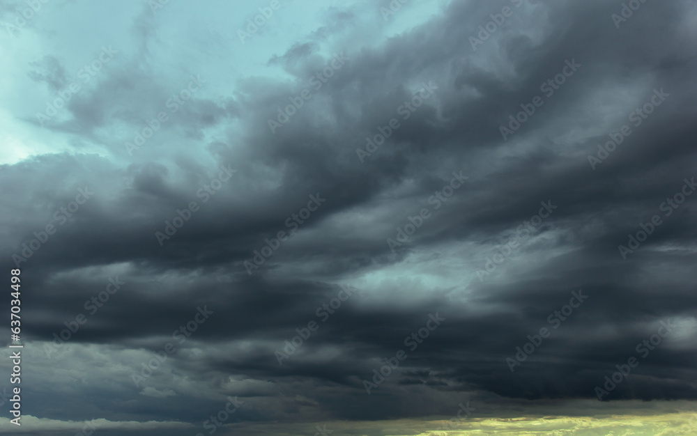 The dark sky with heavy clouds converging and a violent storm before ...
