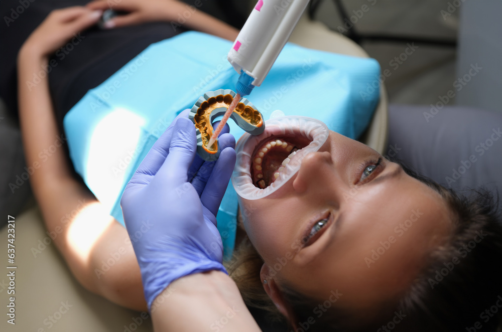 Orthodontist works with shape of jaw cast in process of prosthetics of ...