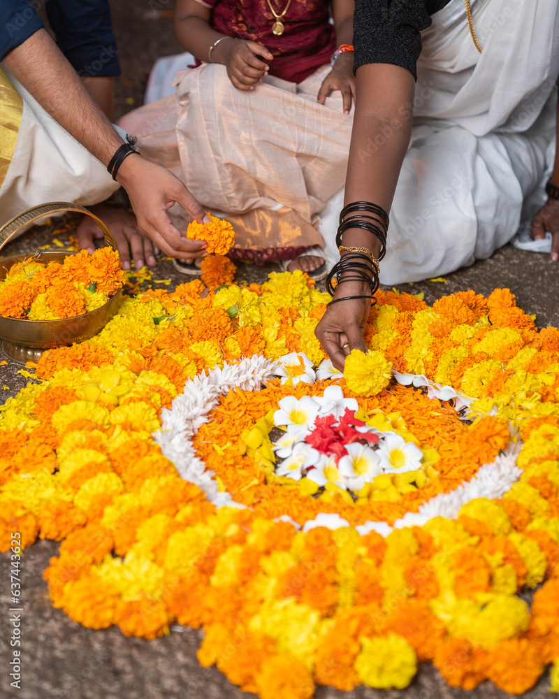 Happy Onam concept image, Indian family making Onam Pookalam with ...