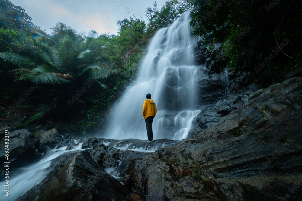 Tourist enjoying the view of beautiful waterfall, shot from Kappimala ...
