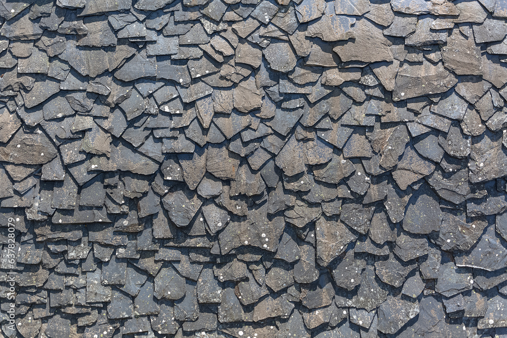 Detailed view of wall texture randomly lined with slate panels, typical ...