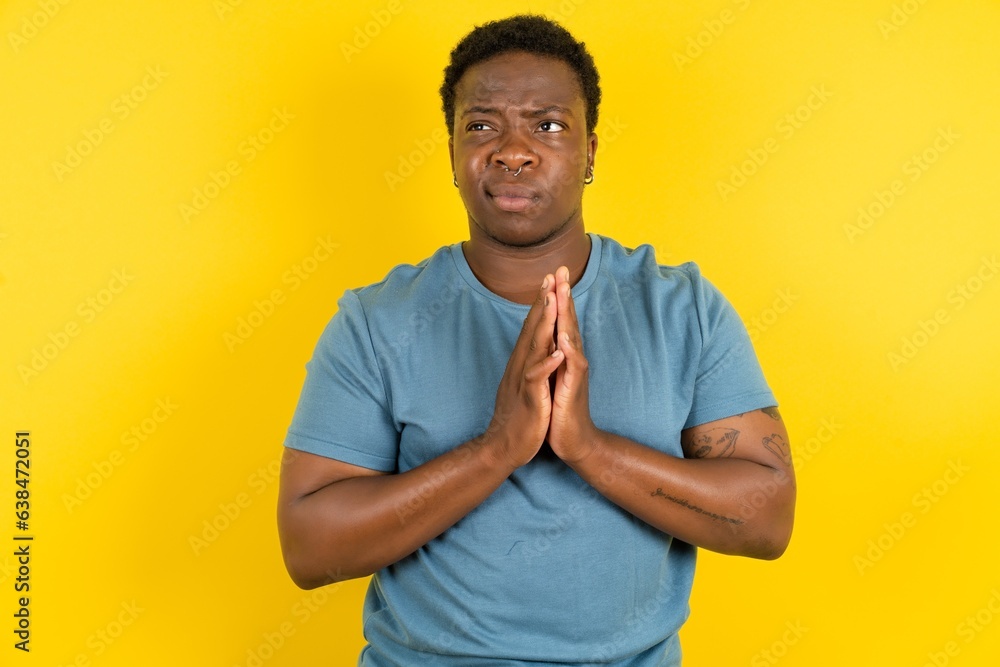 Charming cheerful Young handsome man standing over yellow studio ...